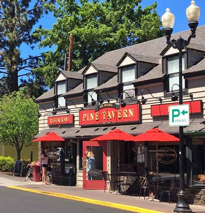 Summer sunshine, red umbrellas, and the promise of hearty meals make this inviting entrance impossible to resist.