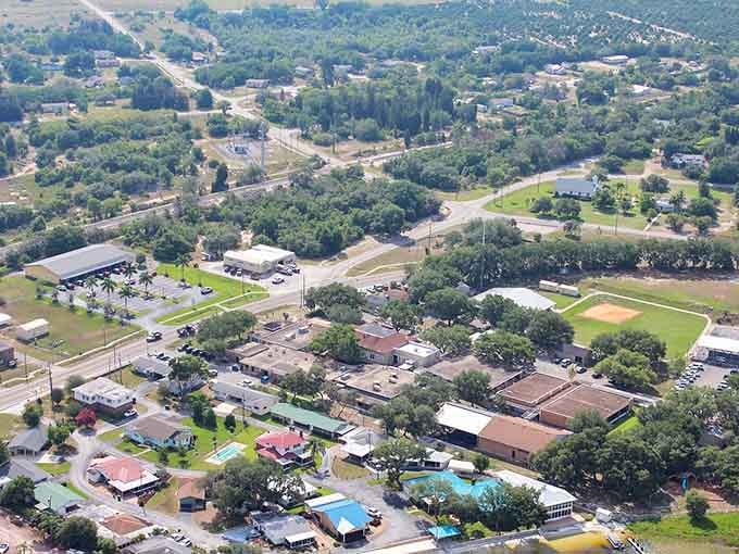 Citrus groves line the roadway in neat rows, their organized beauty a testament to generations of farming tradition still thriving today.