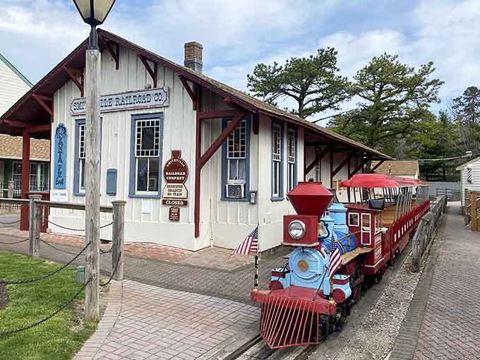 A cheerful miniature train waits beside the old railroad depot, ready to delight visitors young and old alike.