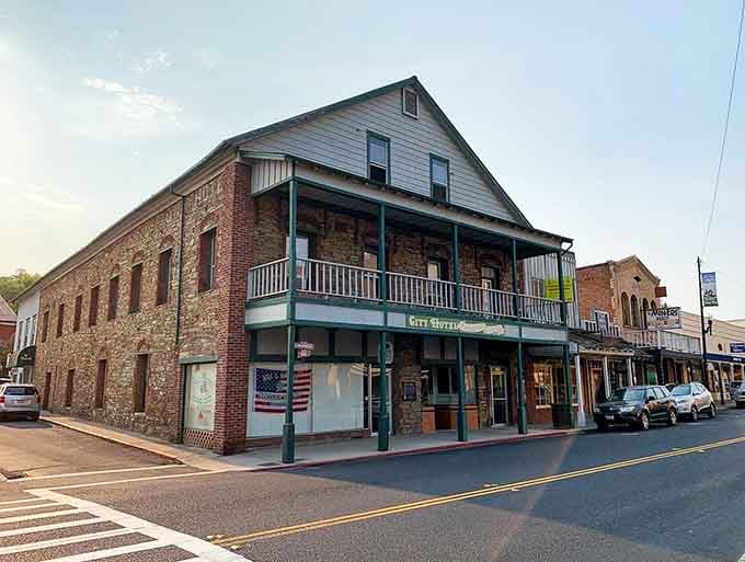 Brick storefronts with vintage balconies create an authentic Western atmosphere where cowboys still feel right at home.