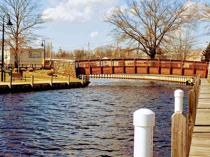 Charming footbridges span gentle waterways, connecting neighborhoods with old-fashioned grace and inviting you to linger awhile longer.