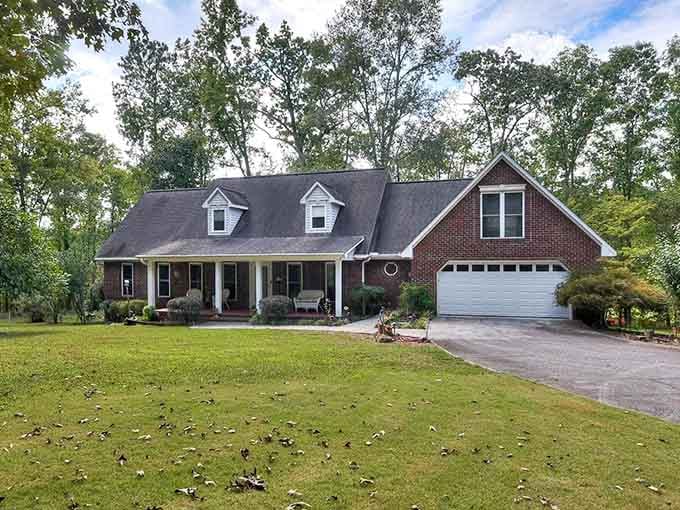 This brick home with its welcoming porch practically begs you to sit down with sweet tea and stay awhile.