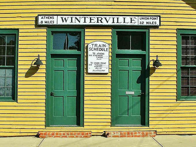 Bright yellow siding and vintage train schedules transport you back when travel meant anticipation, not anxiety.