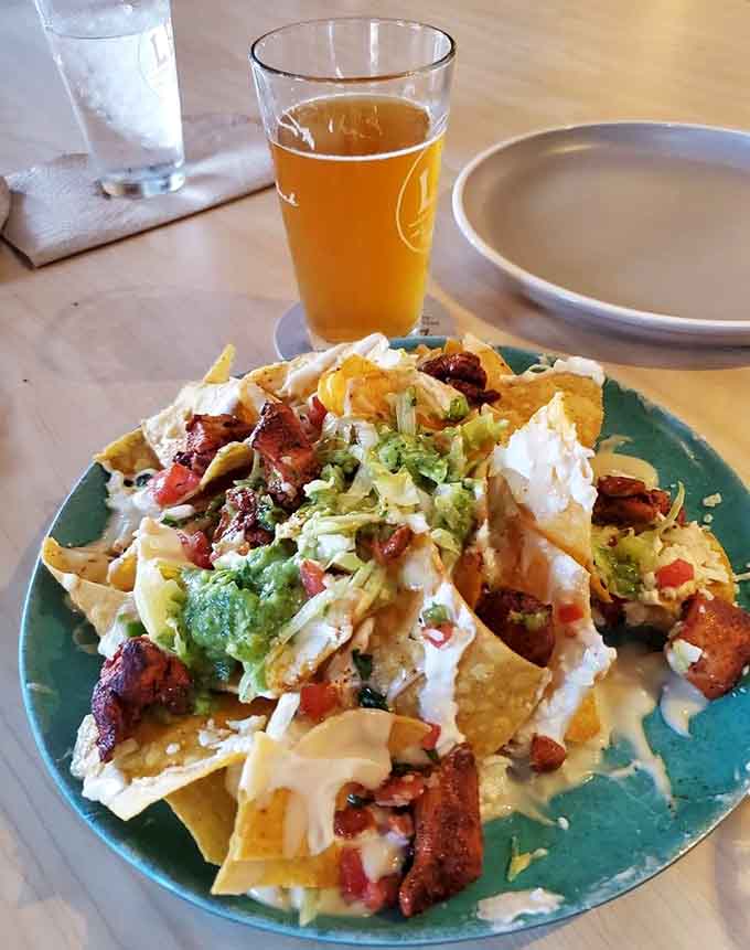 Loaded nachos with a cold beer is the kind of pairing that makes life's problems seem smaller.
