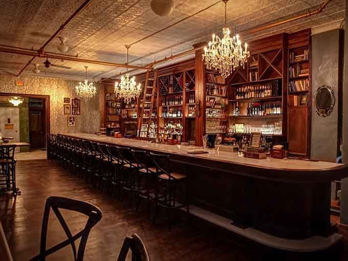 That bar stretches invitingly across the room, stocked with enough bottles to fuel countless memorable evenings ahead.