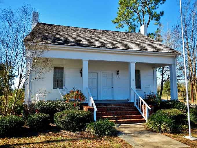 This classic white cottage with black shutters represents Southern architecture at its most elegant and understated best.