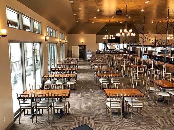 Natural light floods the dining space where windows frame nature's artwork better than any painting could.