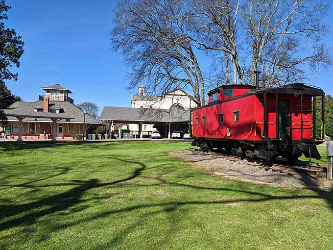 A vintage red caboose sits proudly at the train museum, reminding visitors of Aiken's rich railroad heritage and simpler times.