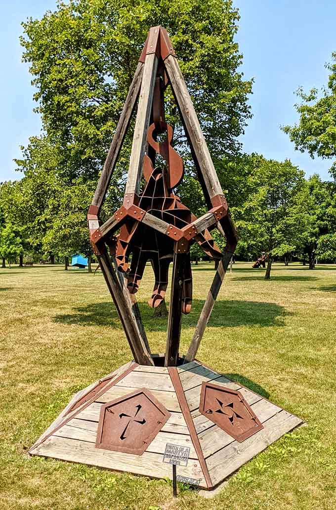 A towering wooden structure reaches skyward with geometric precision, like someone built a cathedral for abstract thought.