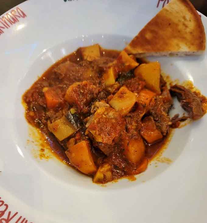 Braised lamb that's been slow-cooked into submission, emerging tender enough to cut with a stern glance and fork.