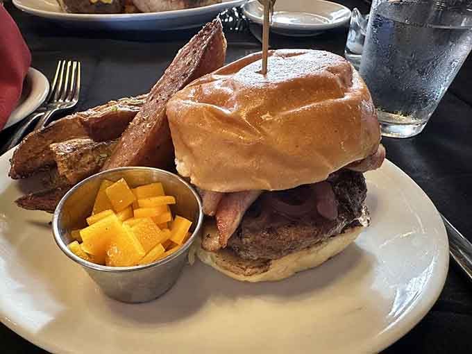 Even the burger gets the royal treatment here, stacked high with bacon and served with fresh fruit.