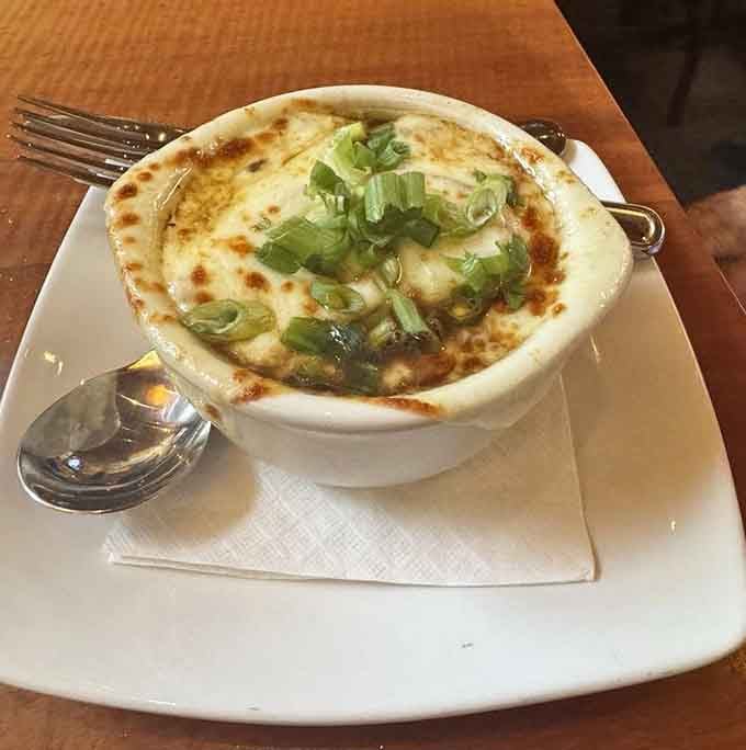 French onion soup bubbling with melted cheese is comfort food that warms you from the inside out, view included.