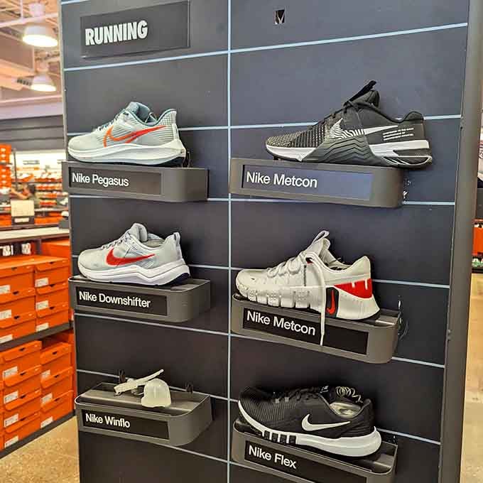 Nike's running shoe display organized like a museum exhibit, because sneakers deserve proper respect and presentation.