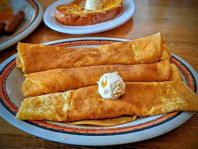 Rolled crepes topped with whipped cream prove that breakfast can be both elegant and completely satisfying at once.