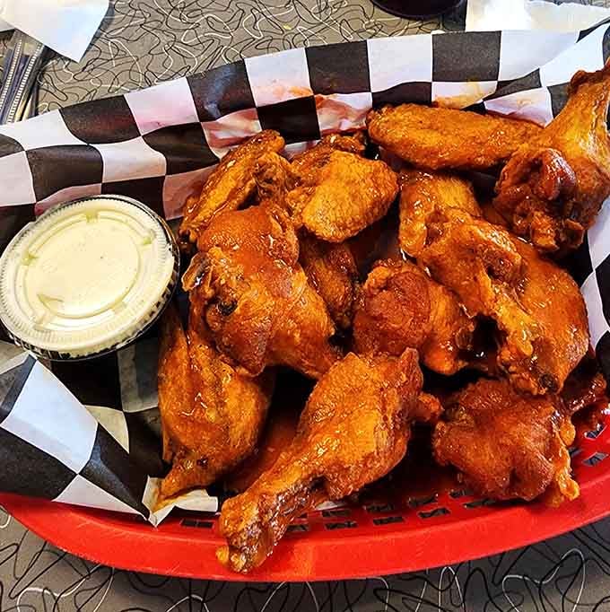 These wings arrive hot, saucy, and plentiful enough to feed your entire bowling league after tournament night.