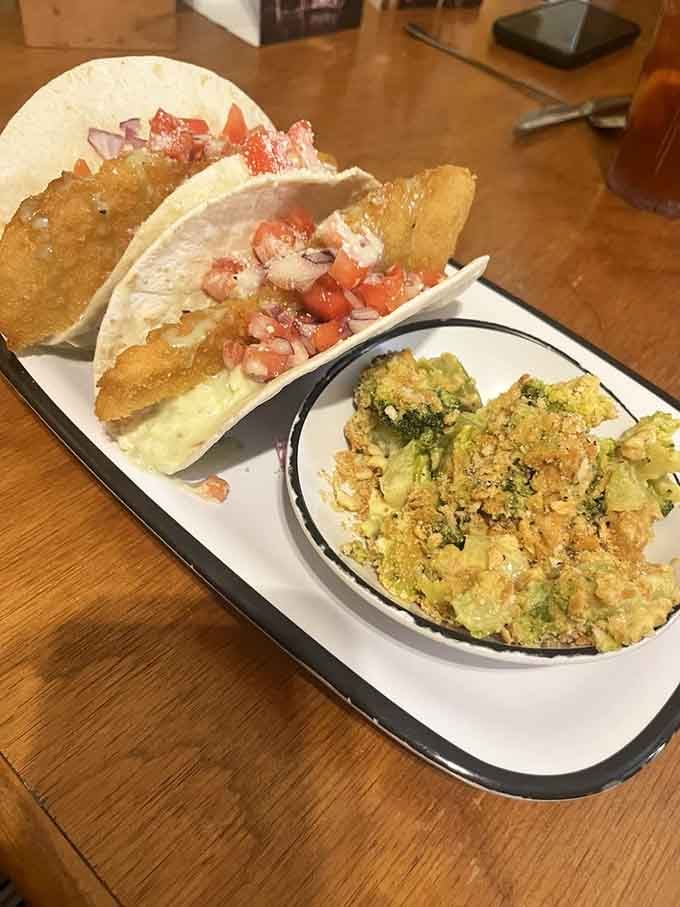 Fish tacos paired with what appears to be their famous broccoli casserole, unexpected combinations that somehow work perfectly together.