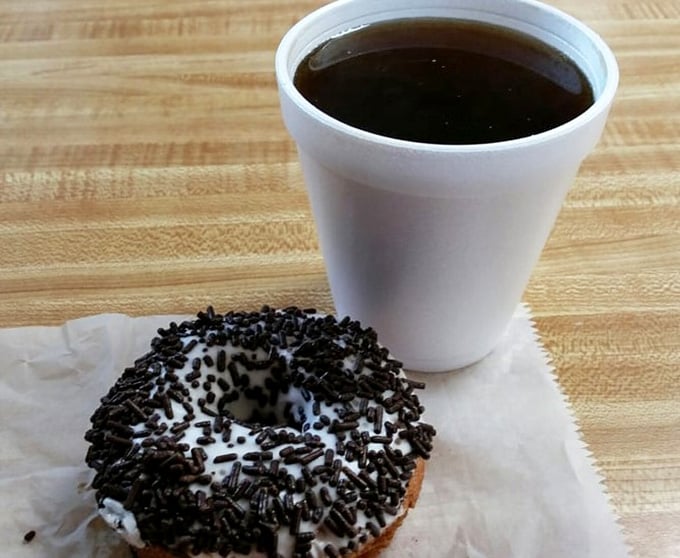 Coffee and a chocolate-sprinkled donut create the kind of morning partnership that deserves its own romantic comedy.