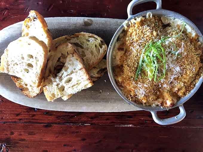 Bubbling hot lobster and artichoke dip with grilled bread ready for dunking is basically a hug in appetizer form.