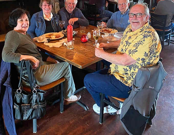 Happy diners sharing laughs and good food capture exactly what makes this place special beyond the menu.