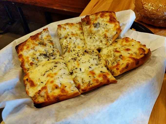 Cheesy bread cut into perfect squares, ready to disappear faster than your New Year's resolutions typically do.