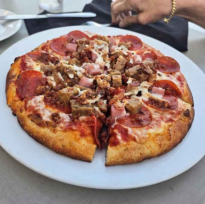 Loaded meat pizza that would make your Italian grandmother nod approvingly before asking for another slice.