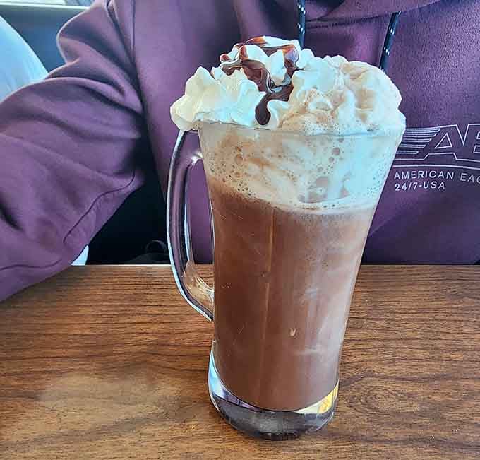 Hot chocolate piled with whipped cream and drizzled with chocolate, warming you from the inside out after coastal adventures.