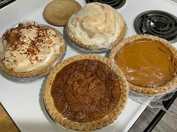 Four homemade pies sitting together like old friends, each one promising to be the perfect ending to your meal.