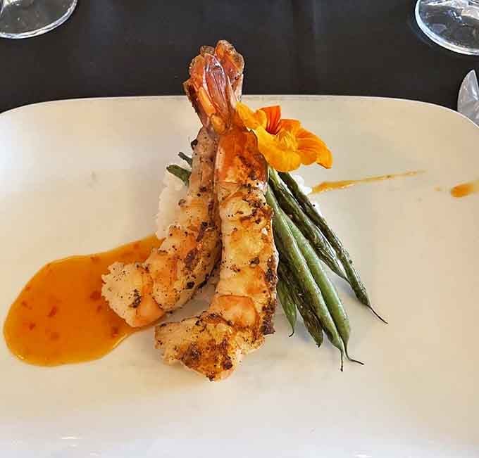 Prawns garnished with edible flowers because beauty and flavor aren't mutually exclusive in fine dining experiences.