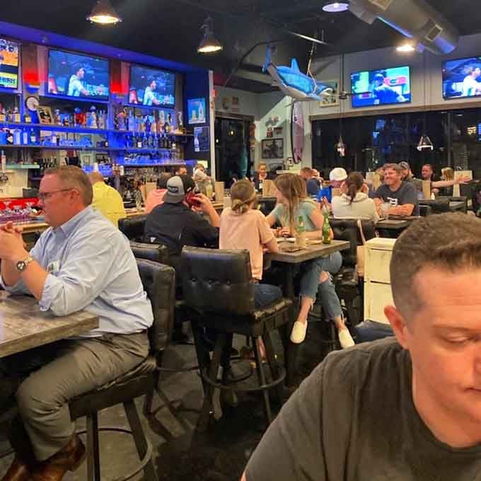 Happy diners, multiple screens, and that relaxed energy that only happens when the food delivers on its promises.