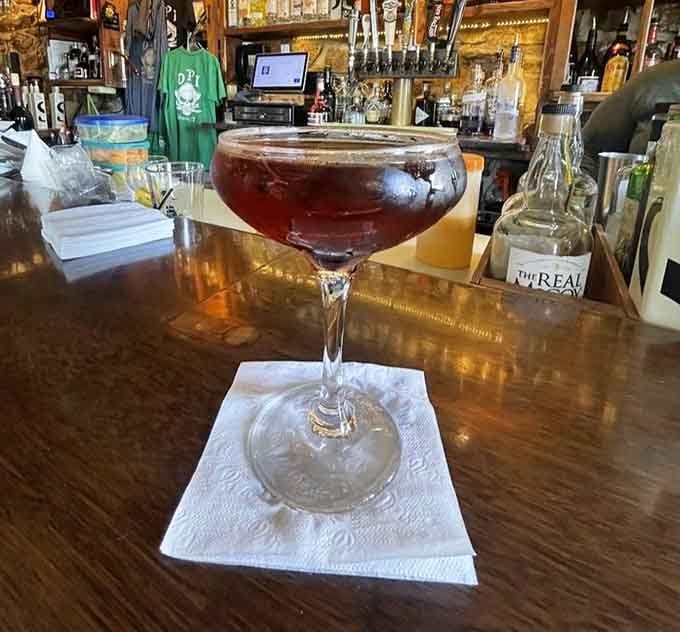 A classic Manhattan in vintage glassware at a historic bar tastes like sipping liquid sophistication from another era.