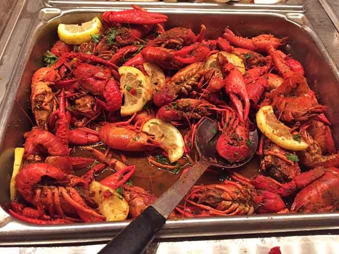 Bright red crawfish glistening with seasoning, looking like they just threw the party of the century.
