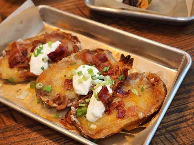 Loaded potato skins topped with bacon, cheese, and sour cream prove comfort food never goes out of style.