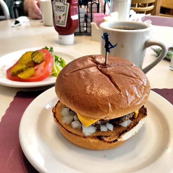 This burger stacked with cheese and onions looks like it walked straight out of a classic diner dream.