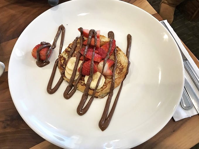 French toast meets croissant in this beautiful marriage, drizzled with chocolate like edible artwork on a plate.