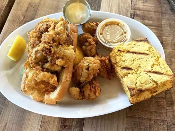 Golden fried oysters piled high on a bun with cornbread on the side, because apparently one carb is never enough.
