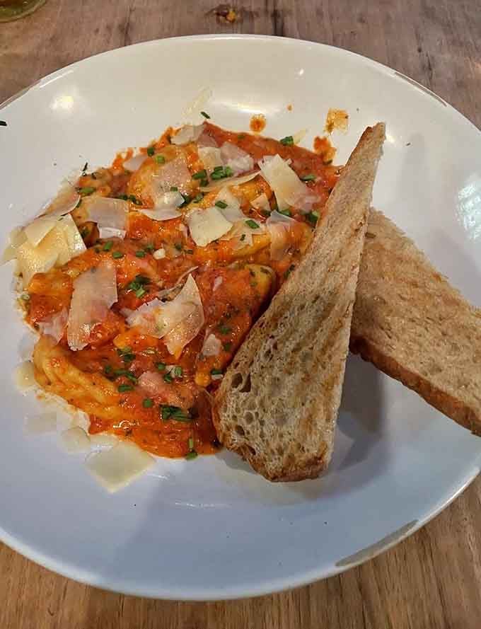 Handmade braided ravioli in rich tomato sauce with crusty bread for sopping up every last delicious drop of goodness.