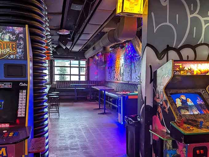 Those circular ceiling lights create an otherworldly glow above the vintage cabinets lining the gaming floor below.