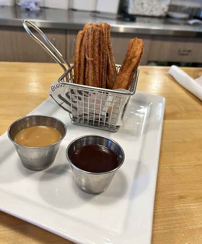 Churros served in a tiny fry basket with dipping sauces, like the county fair came to breakfast.