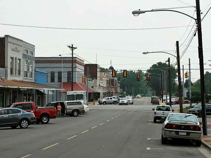 Historic buildings stand shoulder to shoulder along quiet streets where parking spots outnumber the hurried pace of city life.