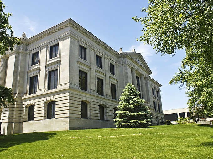 The Hendricks County Courthouse stands like a limestone guardian, reminding everyone that civic buildings used to be actual works of art.