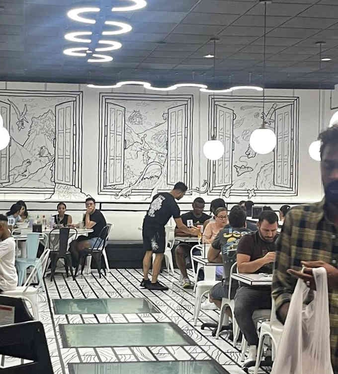 Real people eating real food in a surreal setting, proving this isn't just a fever dream after all.