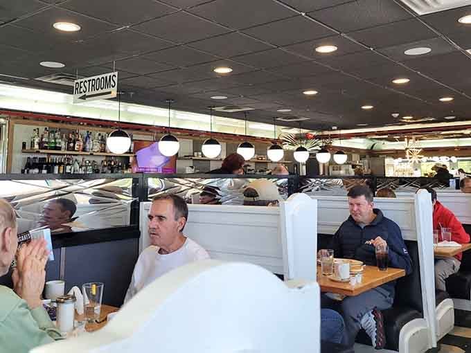 Happy diners in their natural habitat, contemplating whether they need a forklift for these extreme creations or just determination.