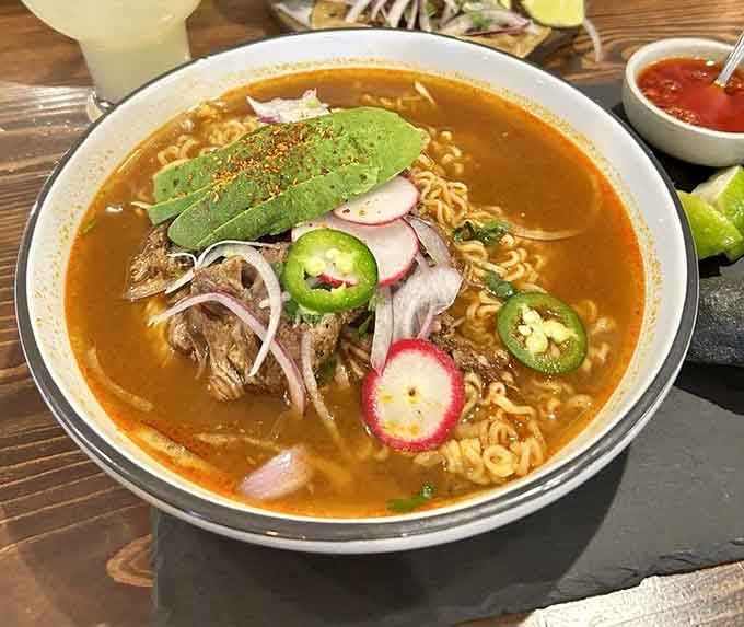 When birria meets ramen, magic happens in a bowl topped with fresh jalape&ntilde;os, radishes, and pure culinary genius.