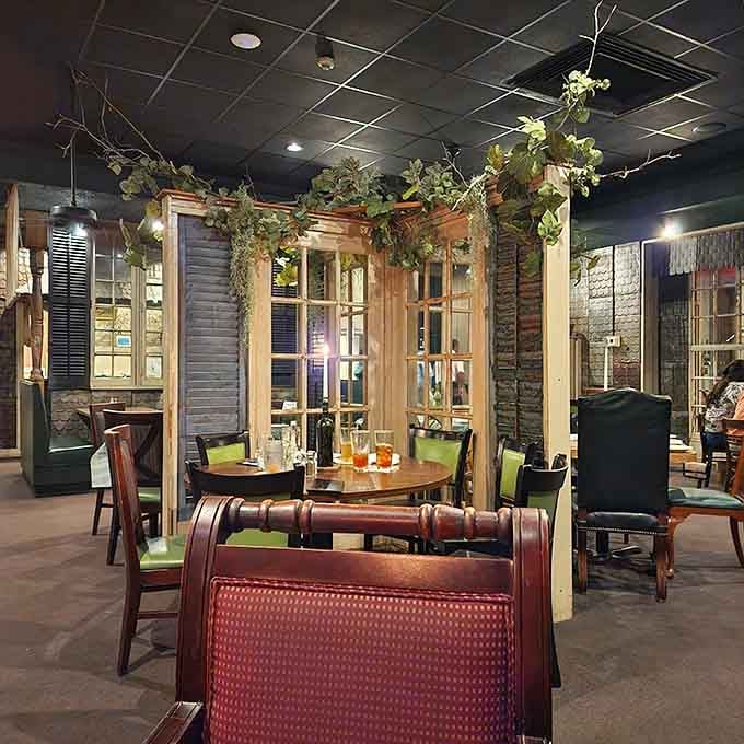 Reclaimed wood dividers and greenery create intimate dining nooks that feel like your own private fish camp retreat.