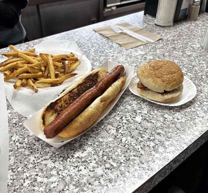The holy trinity: footlong, burger, and fries, proving that some combinations are simply meant to be together.