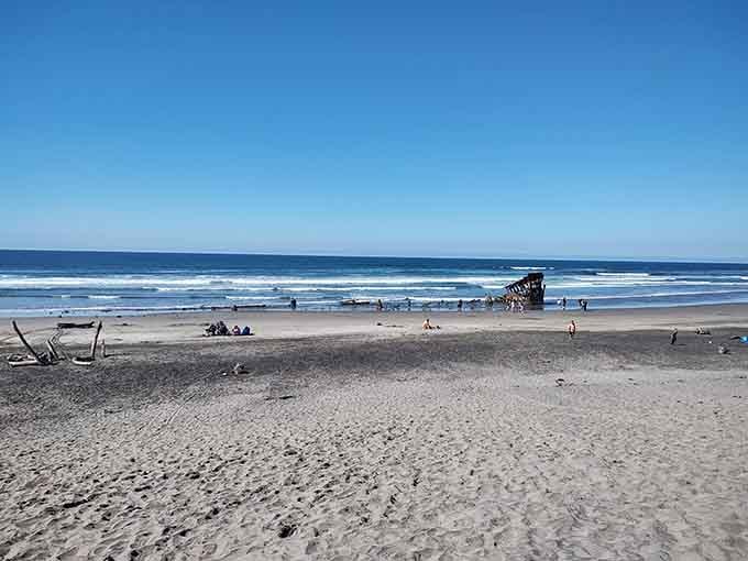 Wide sandy beaches stretch endlessly, with the famous shipwreck standing guard like Oregon's most dedicated, if rusty, lifeguard.