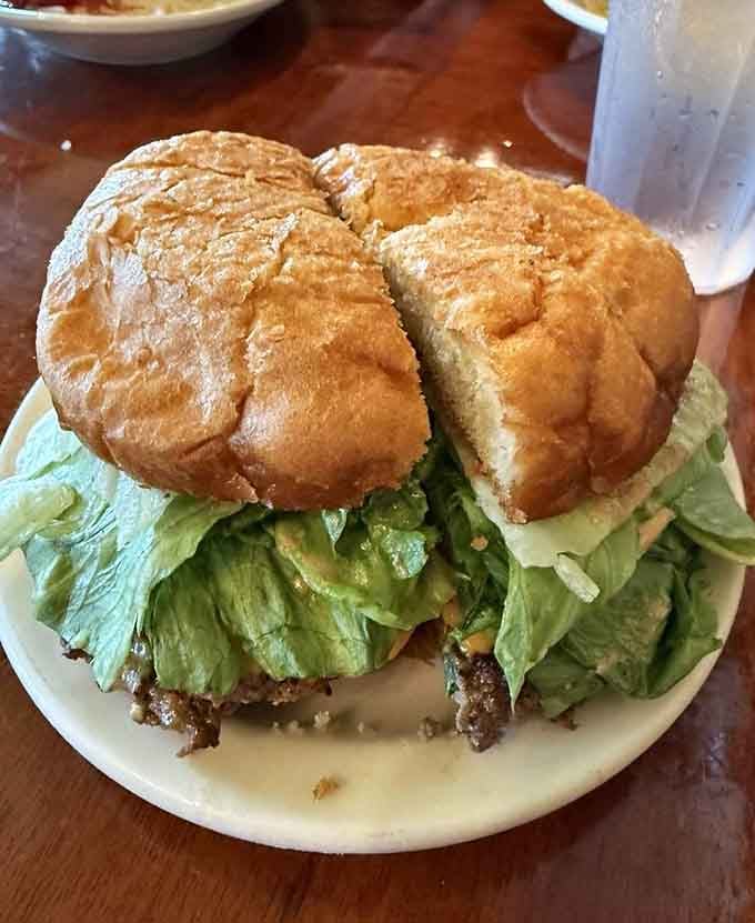 That elk burger is stacked so high it requires both hands and possibly a structural engineer to eat.