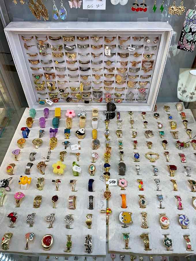 Rings galore sparkle in their display case, offering affordable glamour from more elegant times.