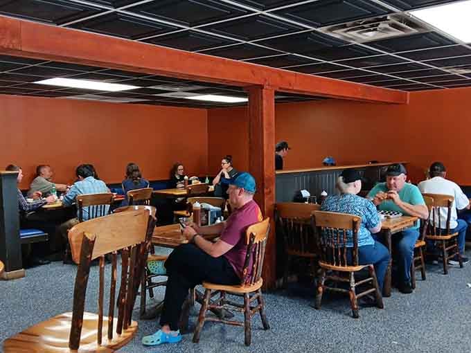 Happy diners enjoying the kind of meal that turns strangers into friends through shared appreciation of excellent barbecue.