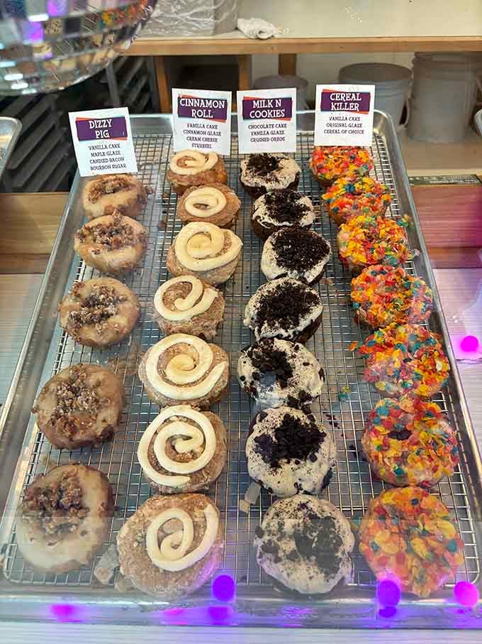 Four perfect rows of creativity, each donut a different adventure, from Dizzy Pig to Milk-N-Cookie to pure imagination.